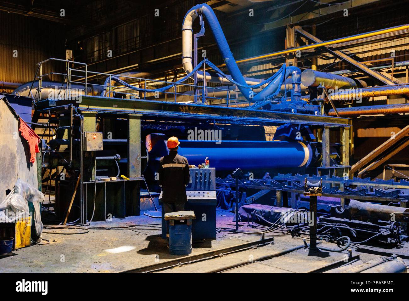 Factory engineer operates pipe painting automatic machine Stock Photo ...