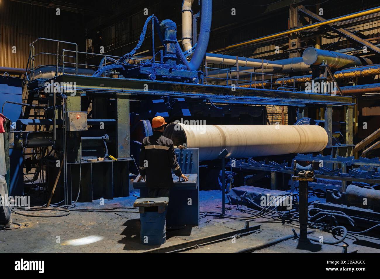 Factory engineer operates pipe painting automatic machine Stock Photo ...