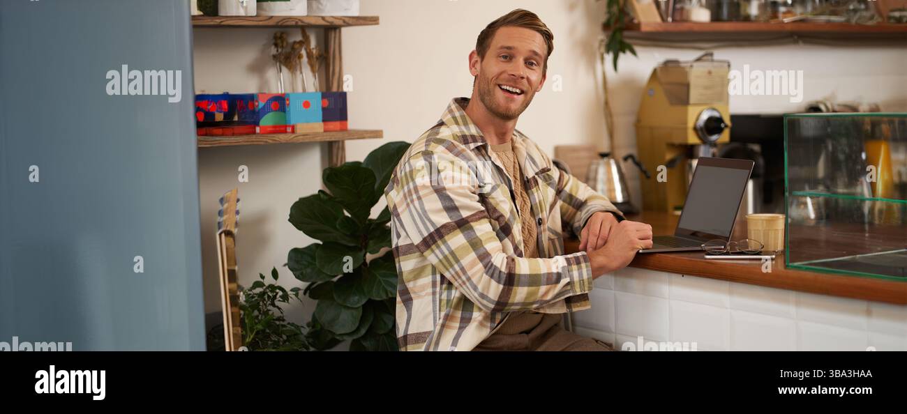 Small business concept. Handsome businessman, cafe owner, sitting near ...