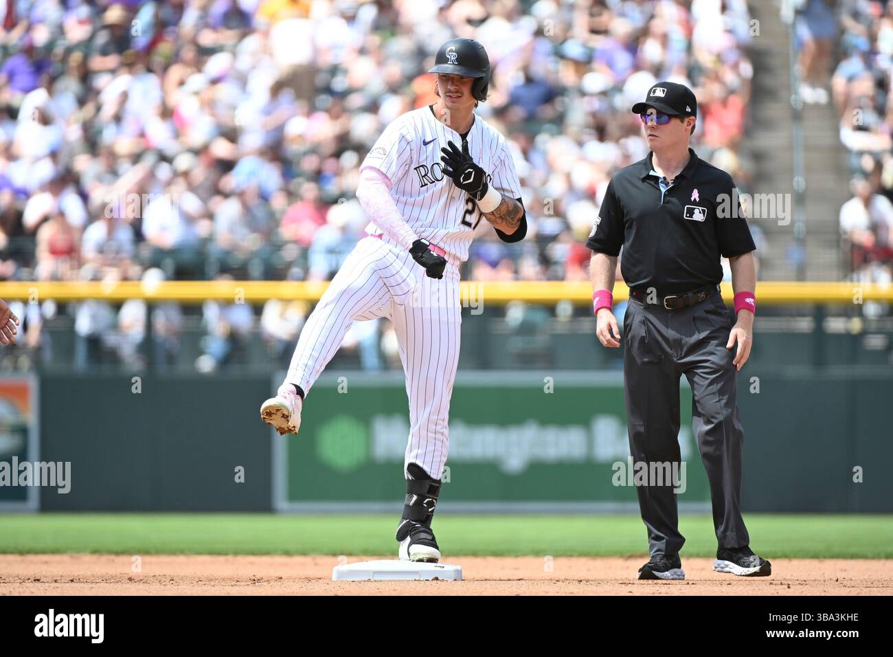 Colorado Rockies' Jordan Beck, left, celebrates after hitting a double ...