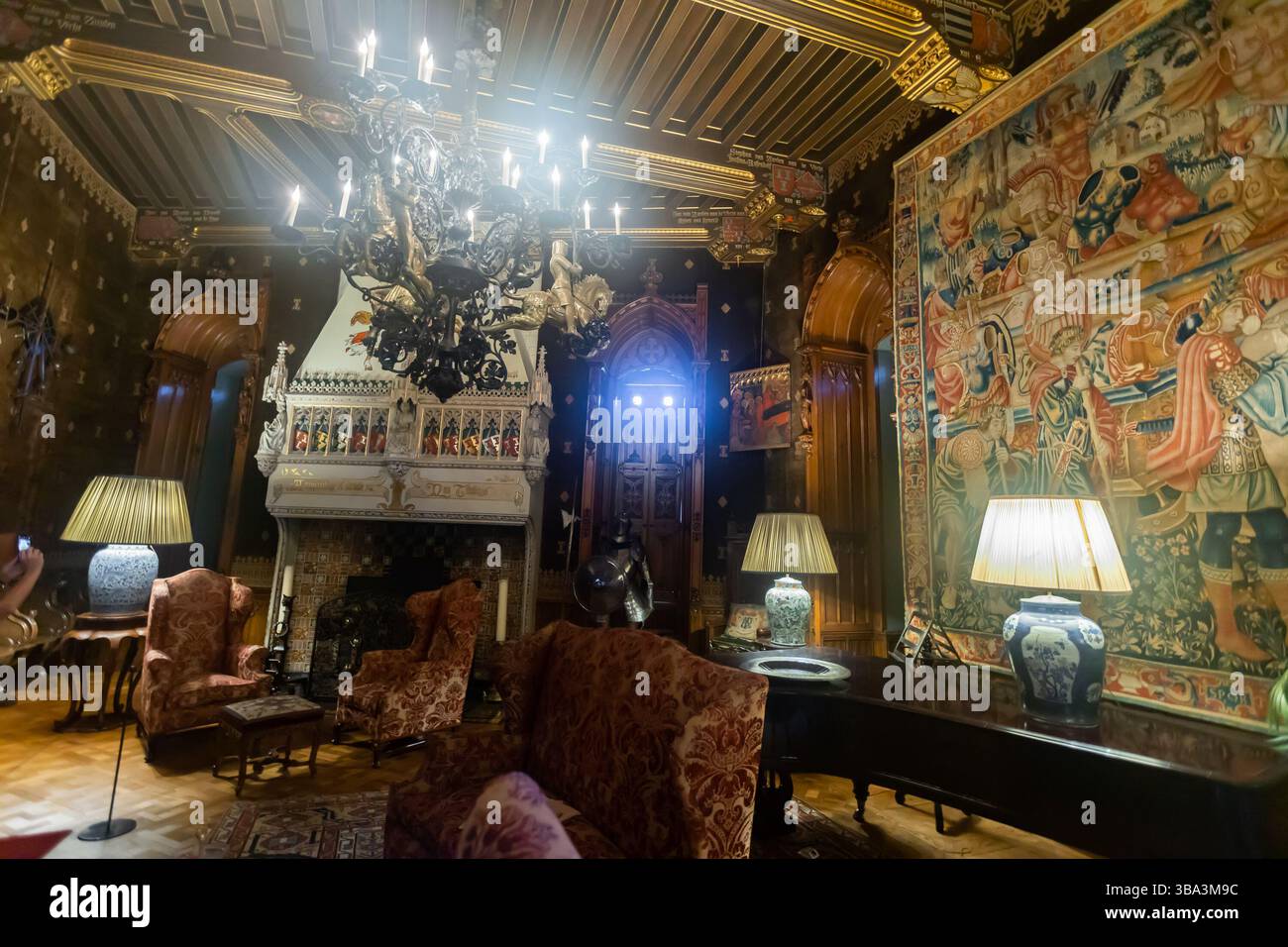 Interior of lounge hall in De Haar Castle with wooden furniture, forged ...