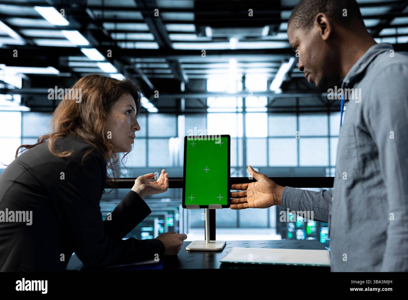 Programmers in data center brainstorming, using mockup tablet ...