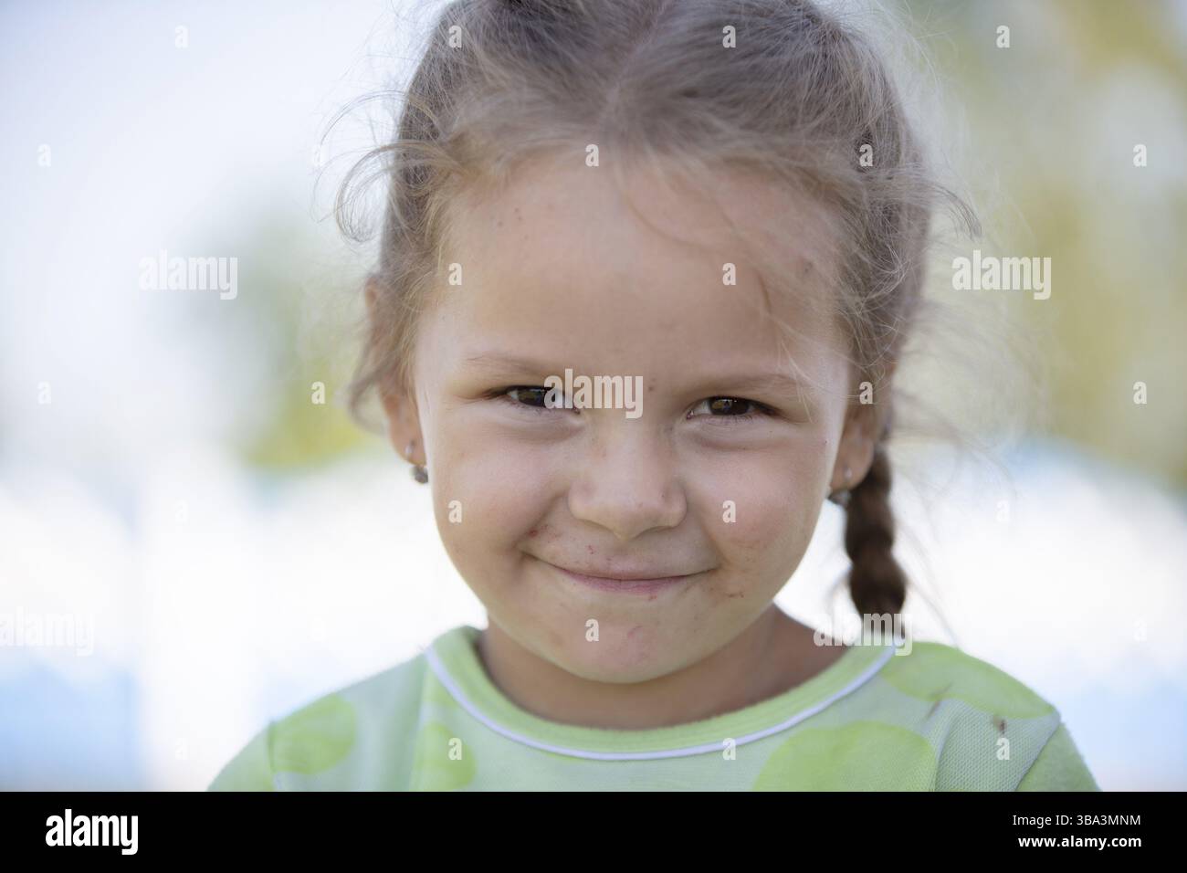 A funny girl with a dirty face looks at the camera and smiles Stock ...