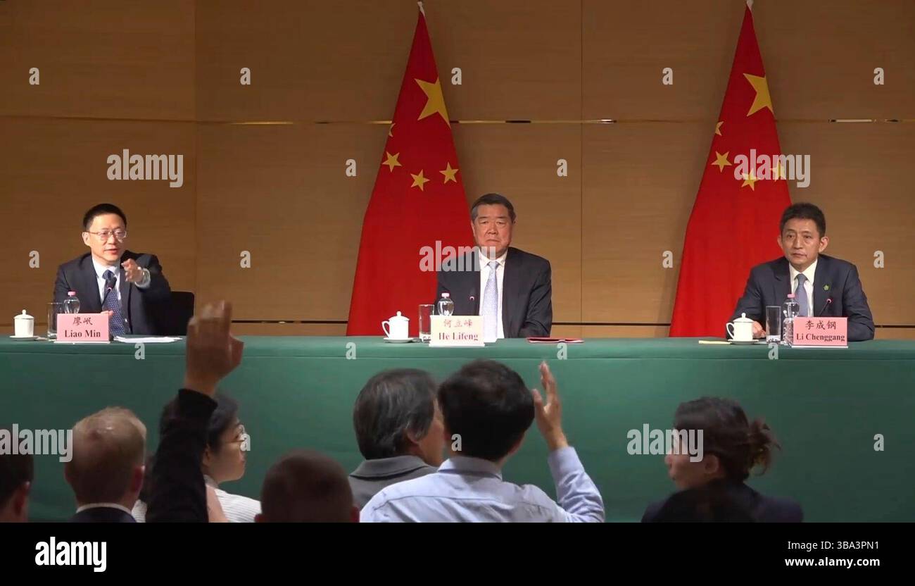 Vice minister of Finance Liao Min, left, gestures toward a journalist ...
