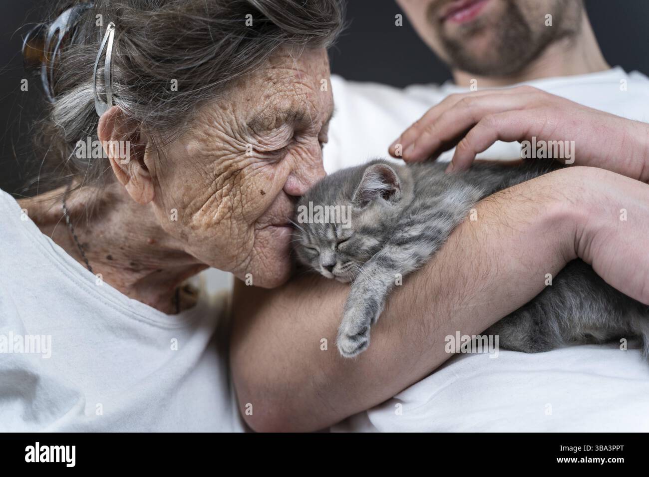 Happy senior woman cuddling and kiss, snuggle up to face small cute ...