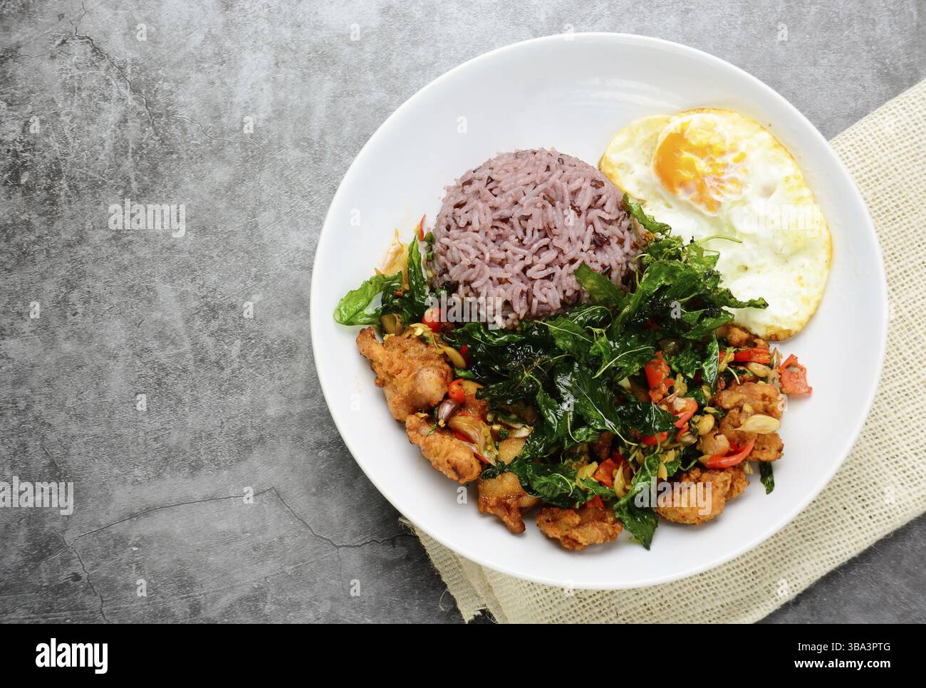 Crispy chicken cooked with green basil, served with steamed rice and ...