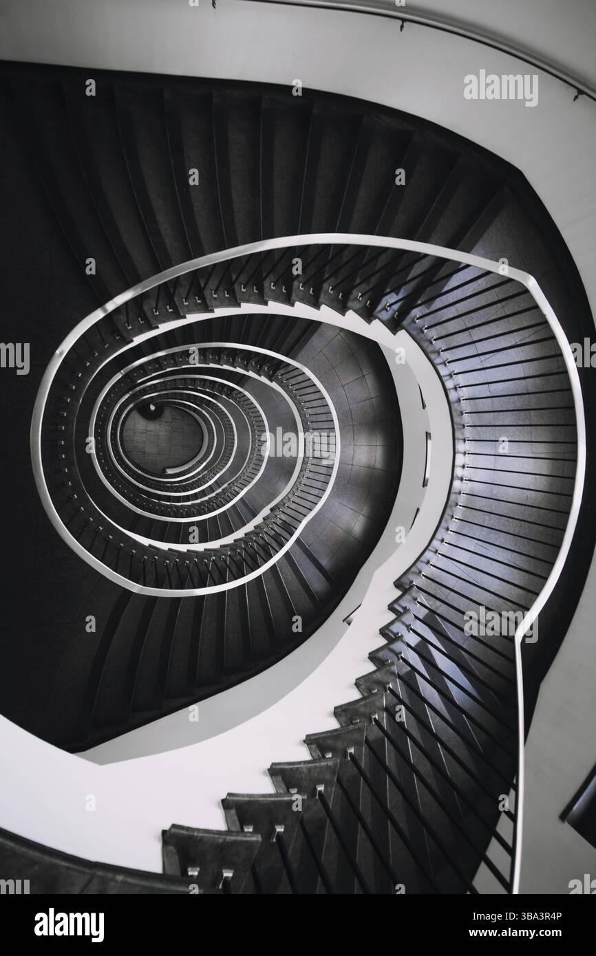 Looking deep into long spiral stair case of big building, concept photo ...