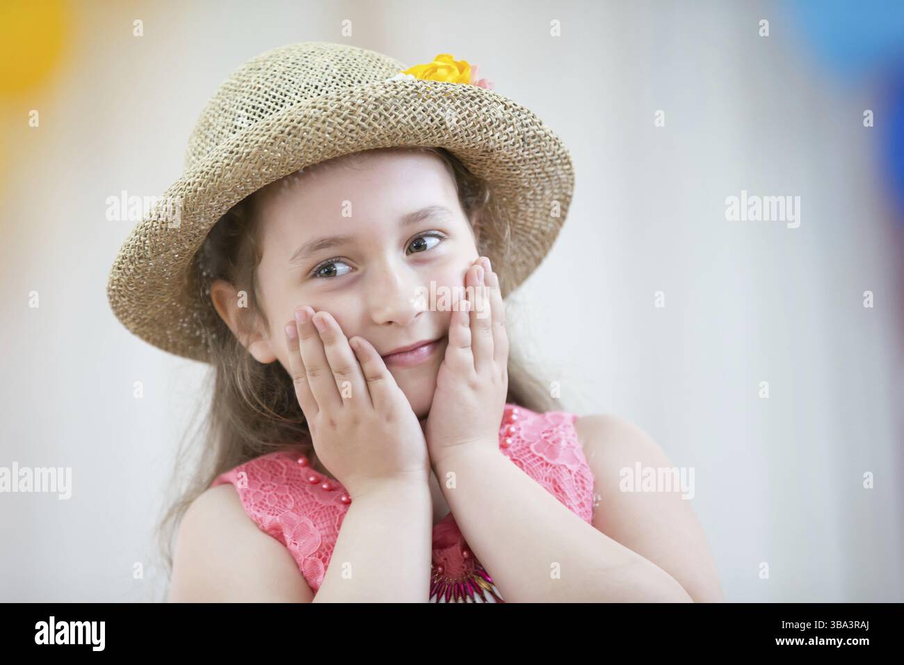 Beautiful preschool girl in a hat admires Stock Photo - Alamy
