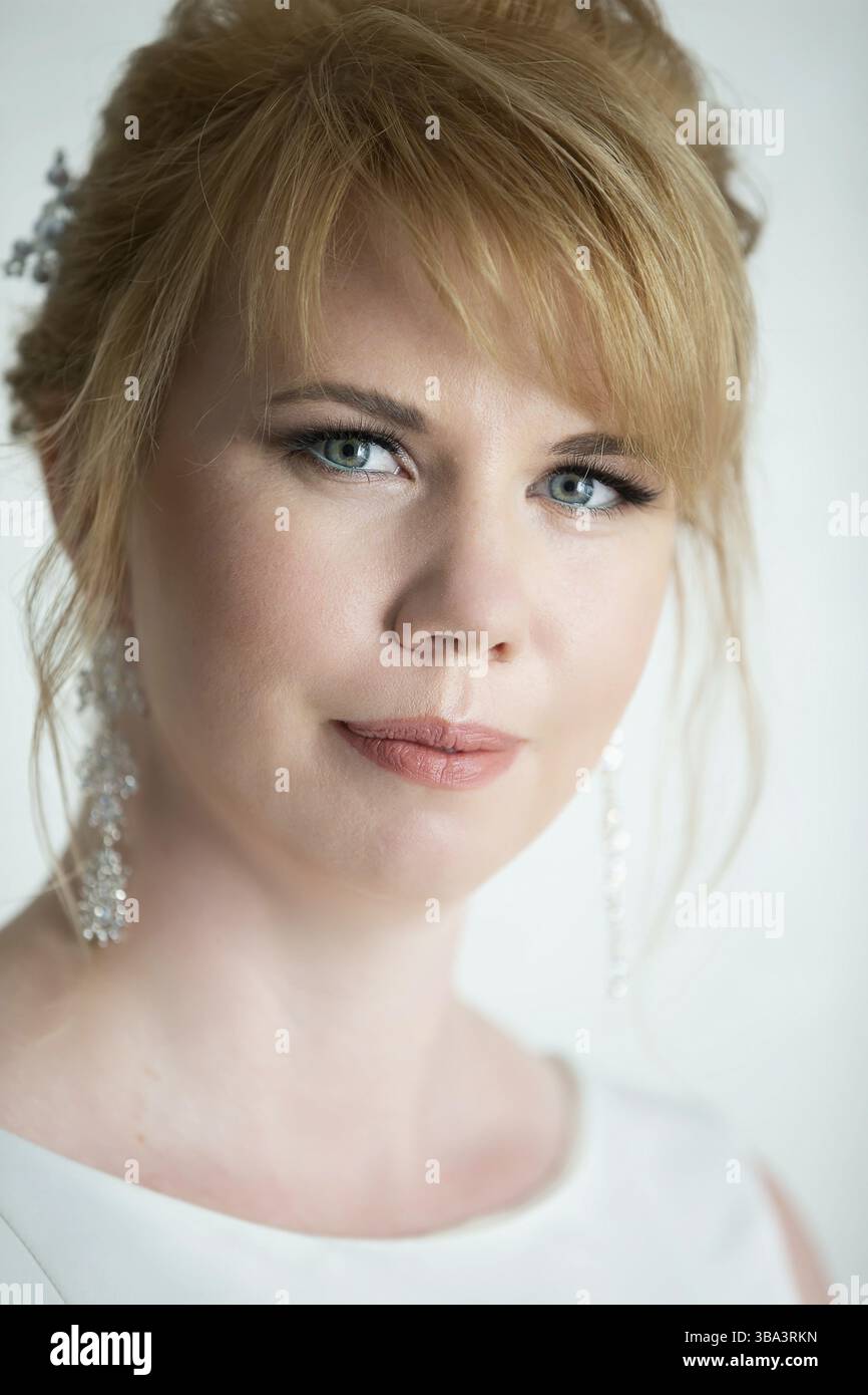 Portrait of a fair-haired blue-eyed girl. The face of a woman of ...