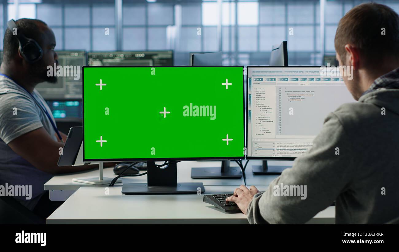 Engineer in server hub using green screen PC to repair equipment ...