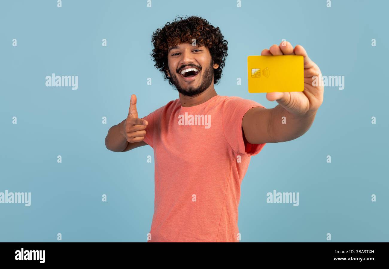 Happy hindu guy pointing at credit card in his hand Stock Photo - Alamy