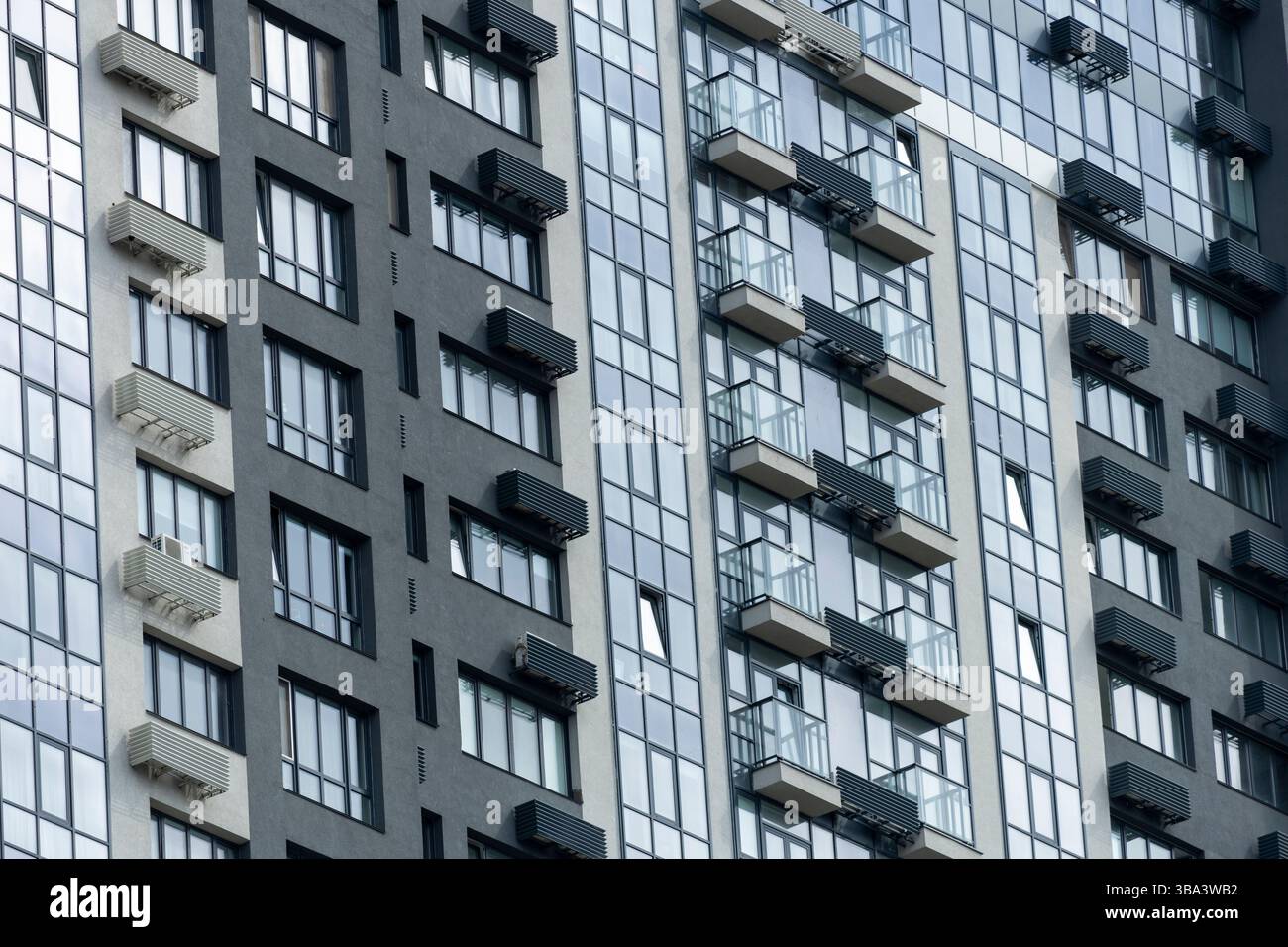 A very tall building featuring numerous windows and plenty of balconies, creating a striking ...