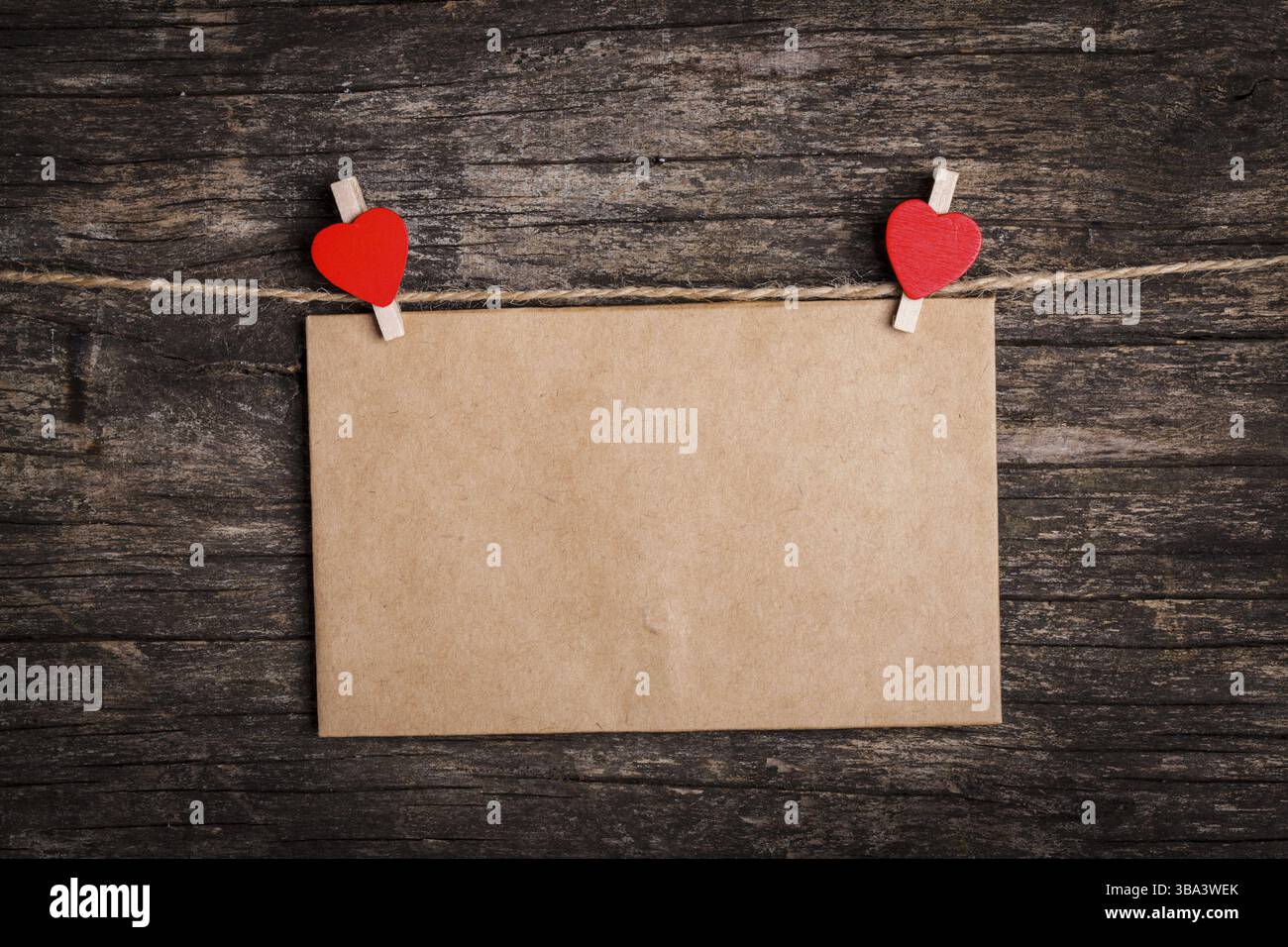 Two hearts attached to the rope. Valentine greetings Stock Photo - Alamy