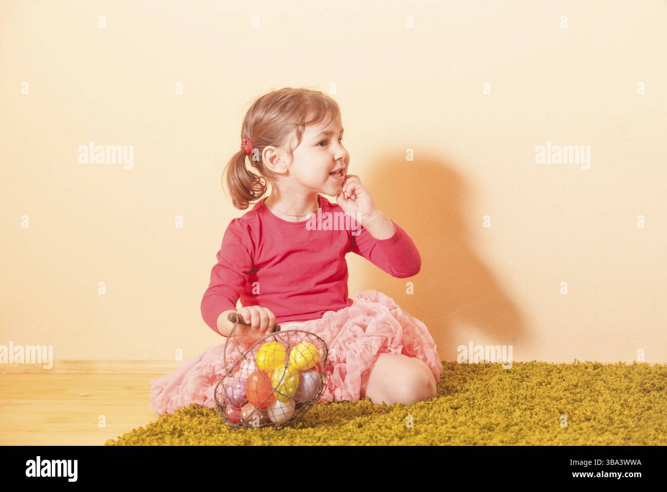 Kid gathers colorful eggs to the baskets on Easter Egg hunt Stock Photo ...