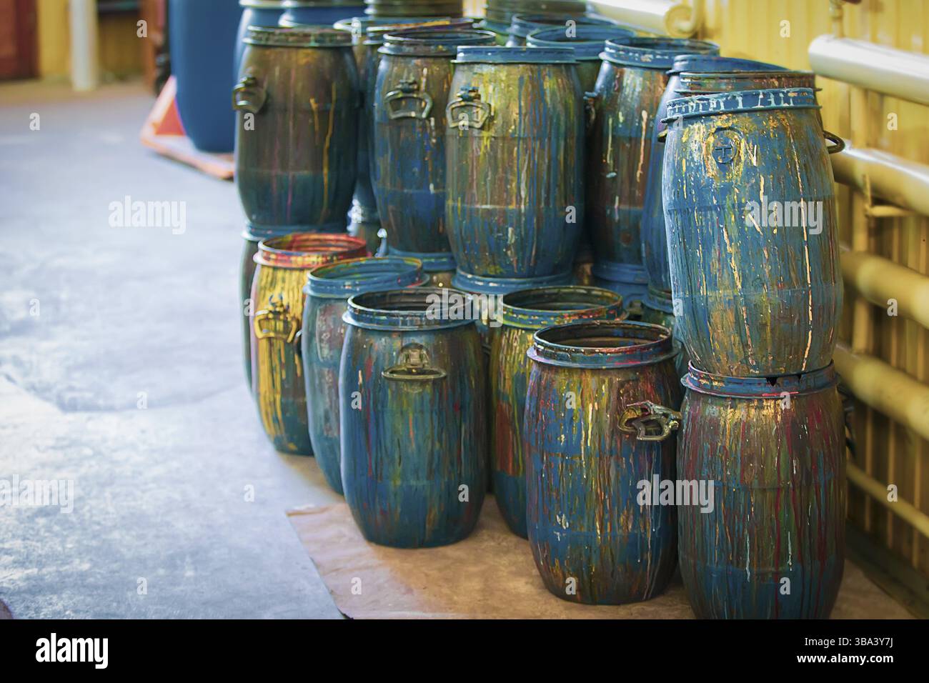 Barrels of paint at the wallpaper factory. Dirty containers with stains ...