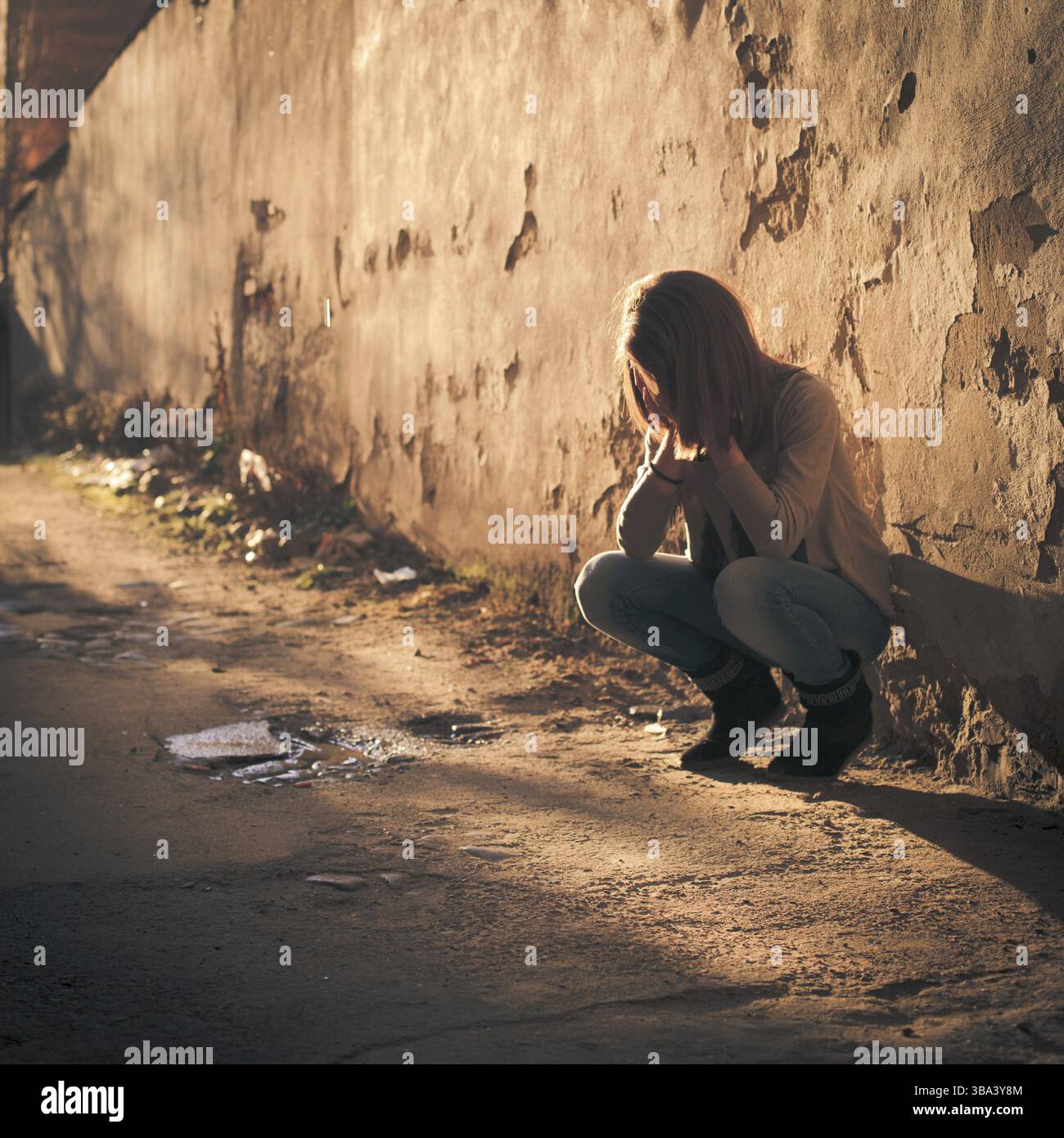 Sad teenage girl crying in the dirty poor ghetto Stock Photo - Alamy