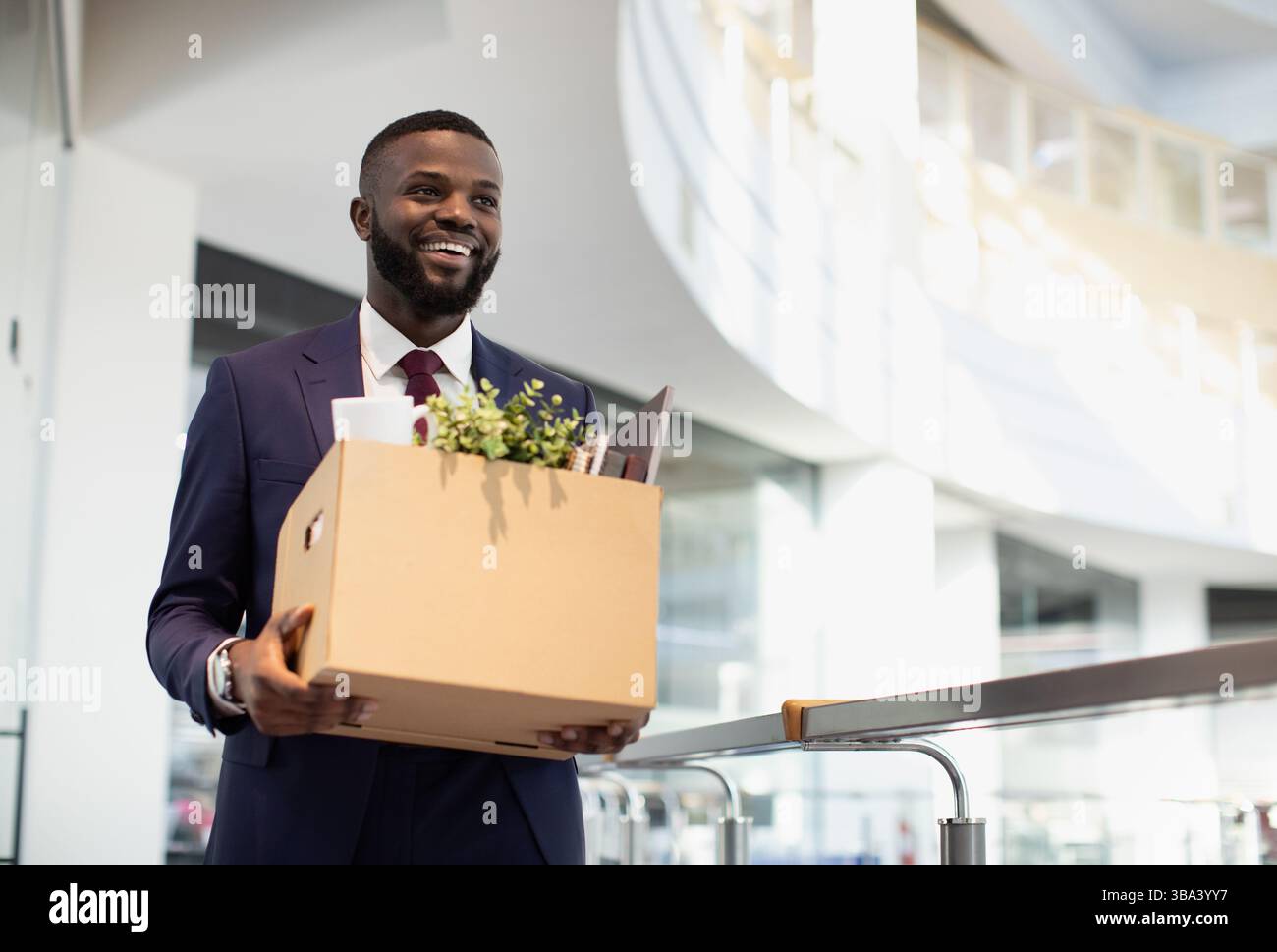 Happy african american young man with working stuff Stock Photo - Alamy