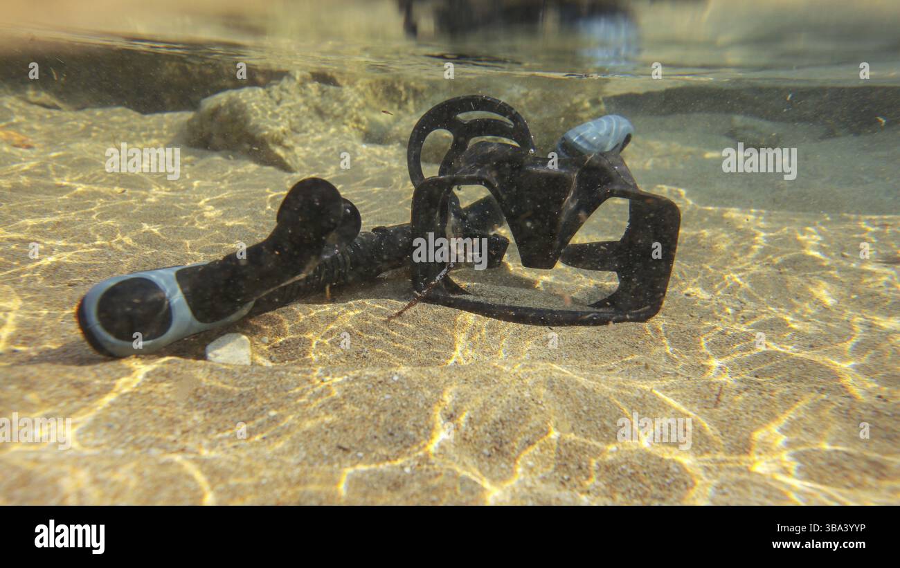 Underwater photo, black snorkel and diving mask on sand in shallow ...