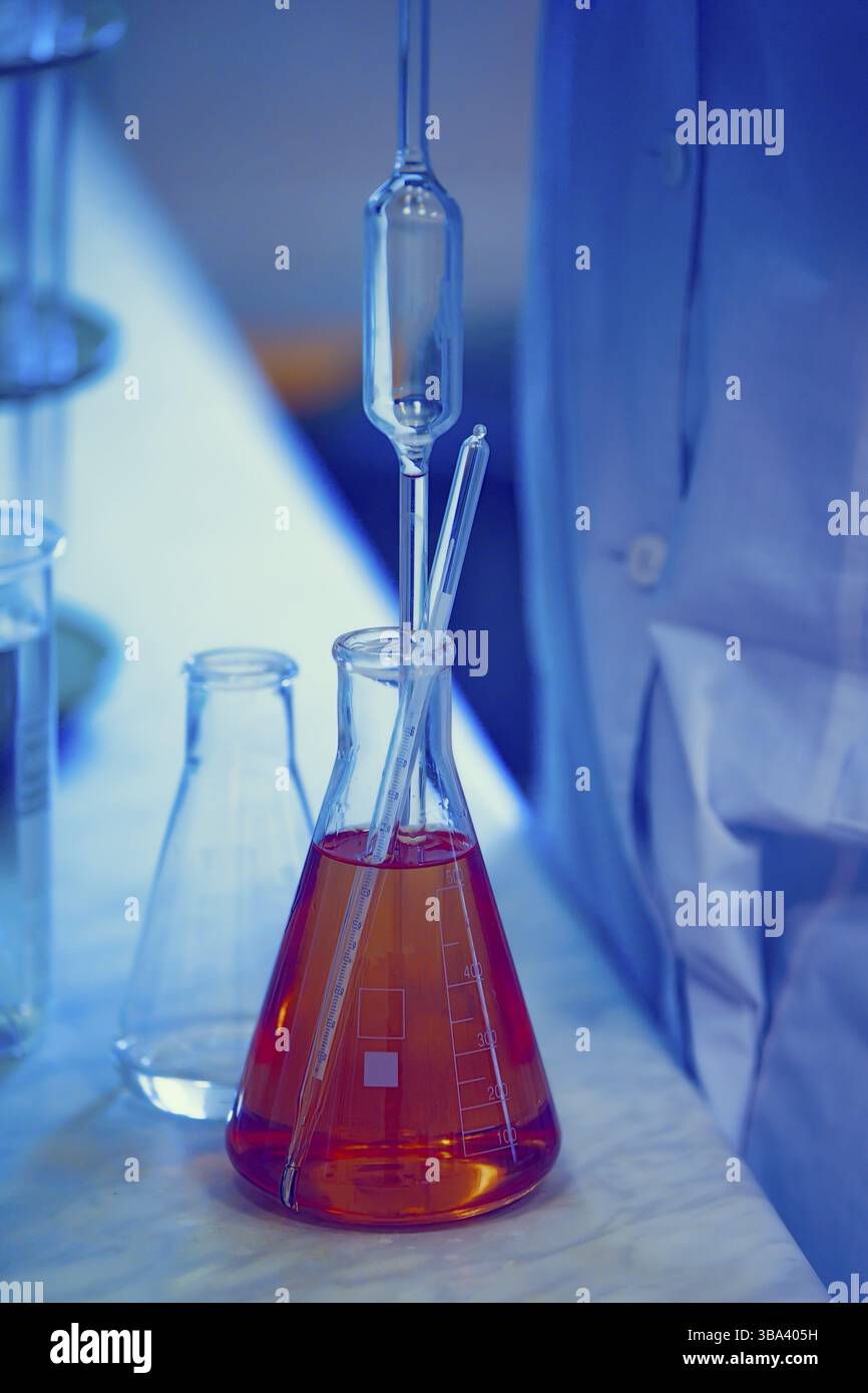 Vaccine production laboratory. Glass flasks with a chemical liquid in ...