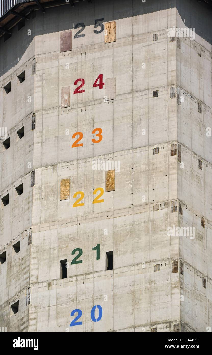 Tall modern skyscraper construction, concrete walls with numbers ...