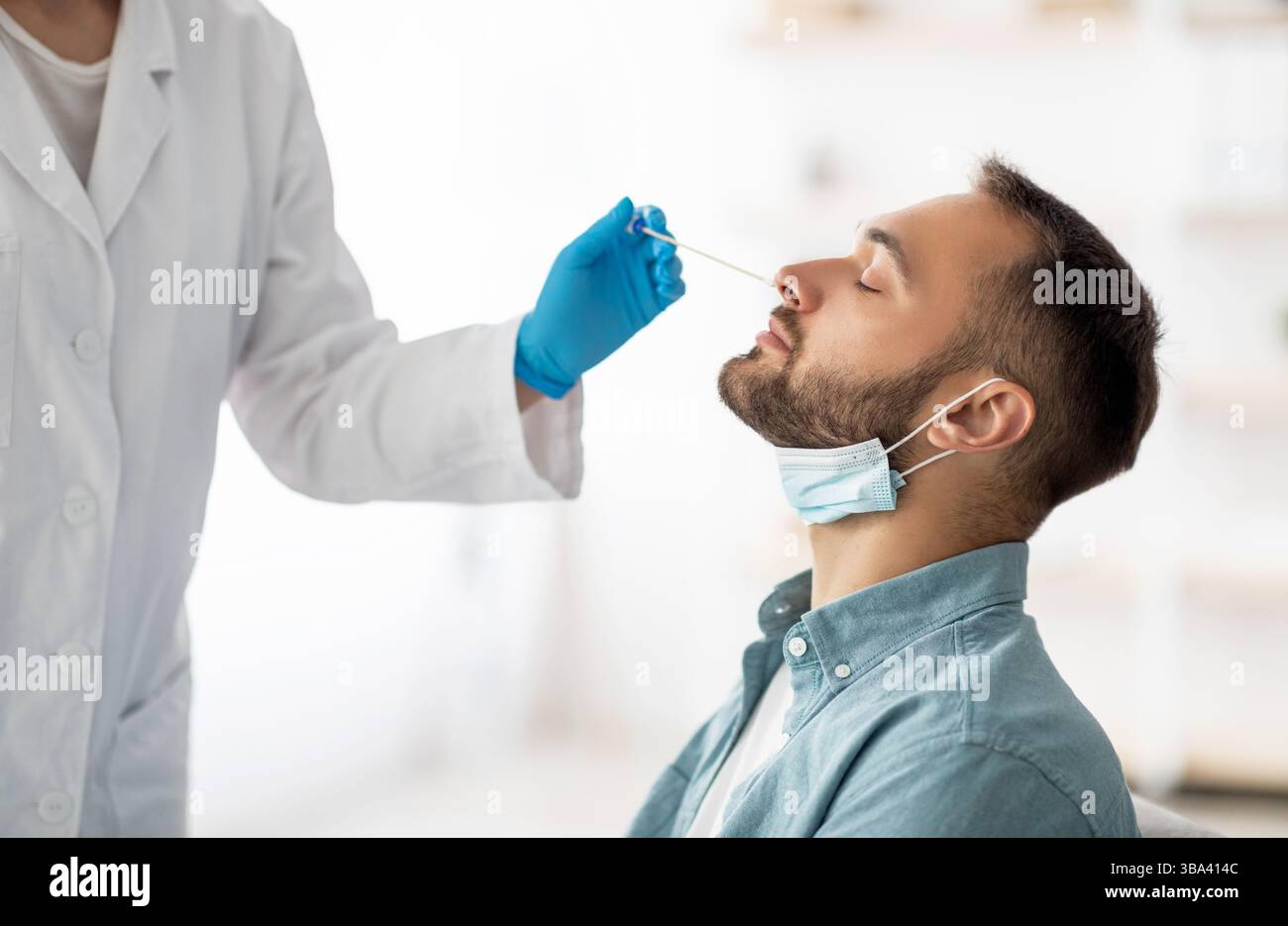 Coronavirus testing procedure. Doctor making nasal PCR test for ...
