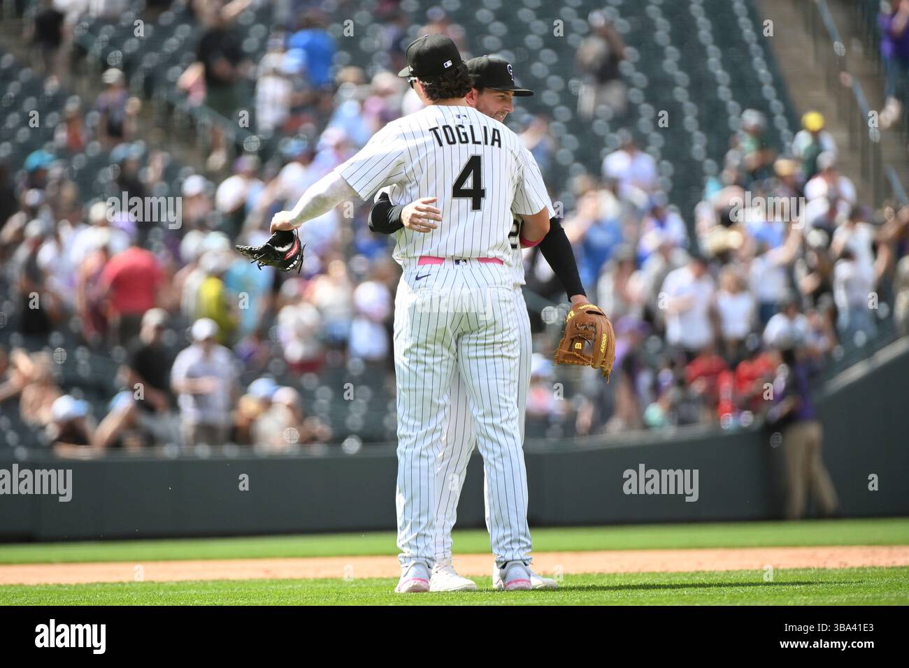 Colorado Rockies first baseman Michael Toglia (4) and third baseman ...