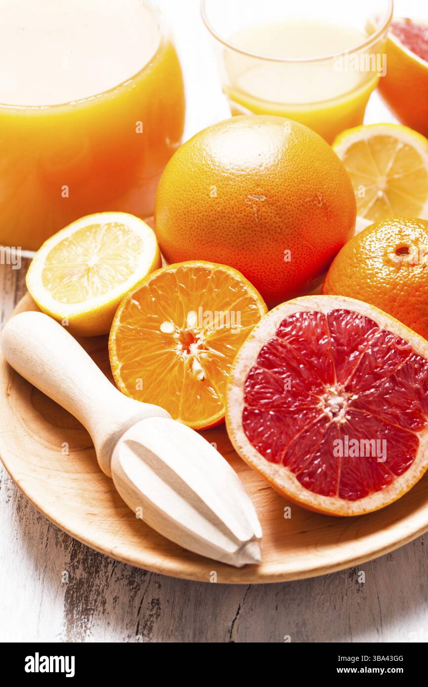 The preparation for citrus juice for breakfast. Wooden citrus reamer ...