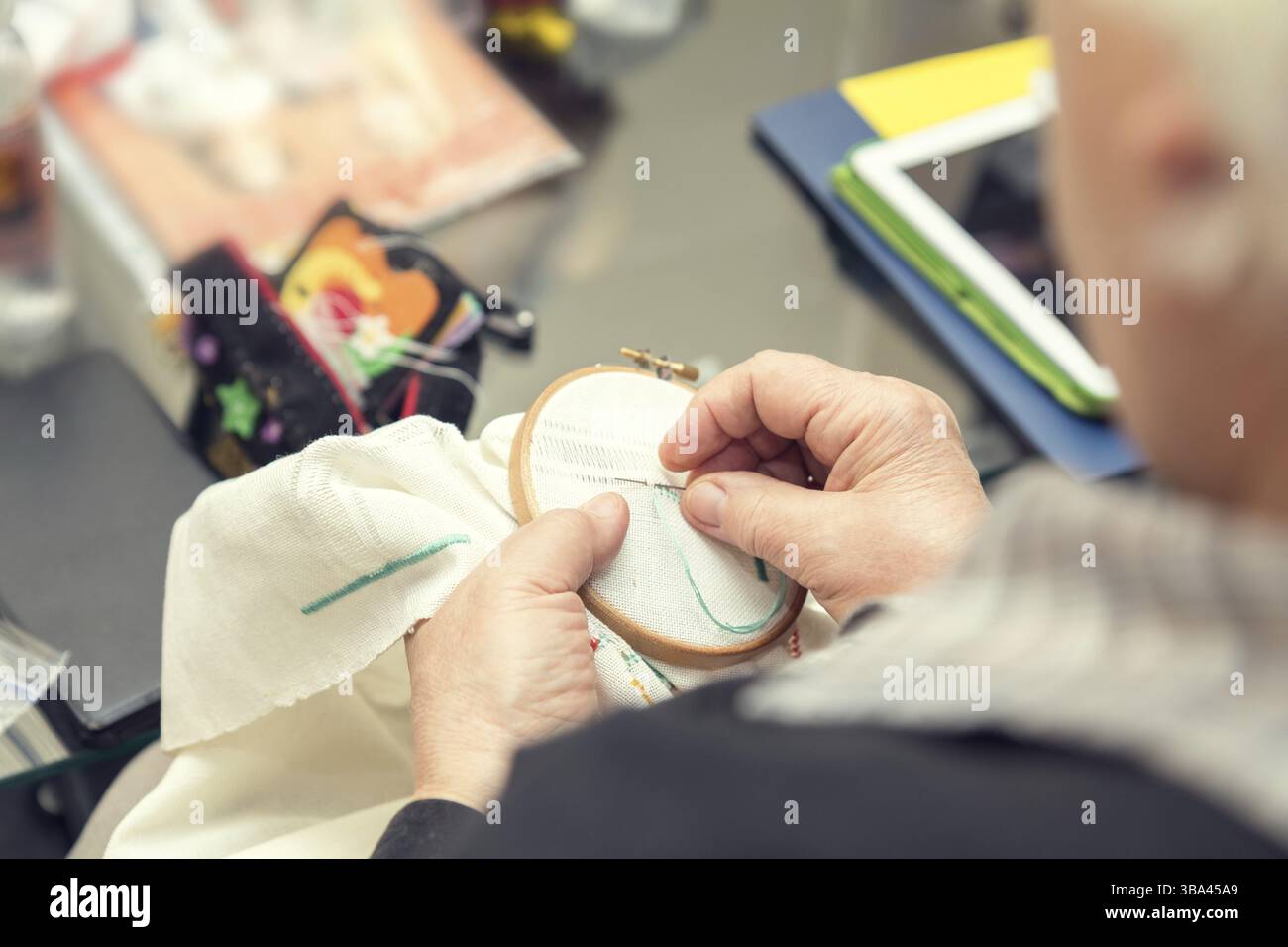 Woman hands doing openwork embroidery on homespun linen. Close up ...