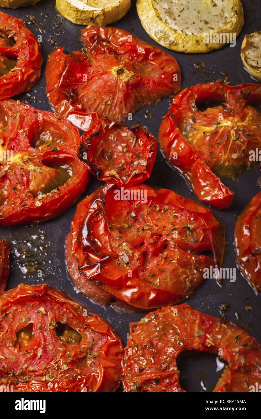 Baked red tomato rings on the frying pan Stock Photo - Alamy