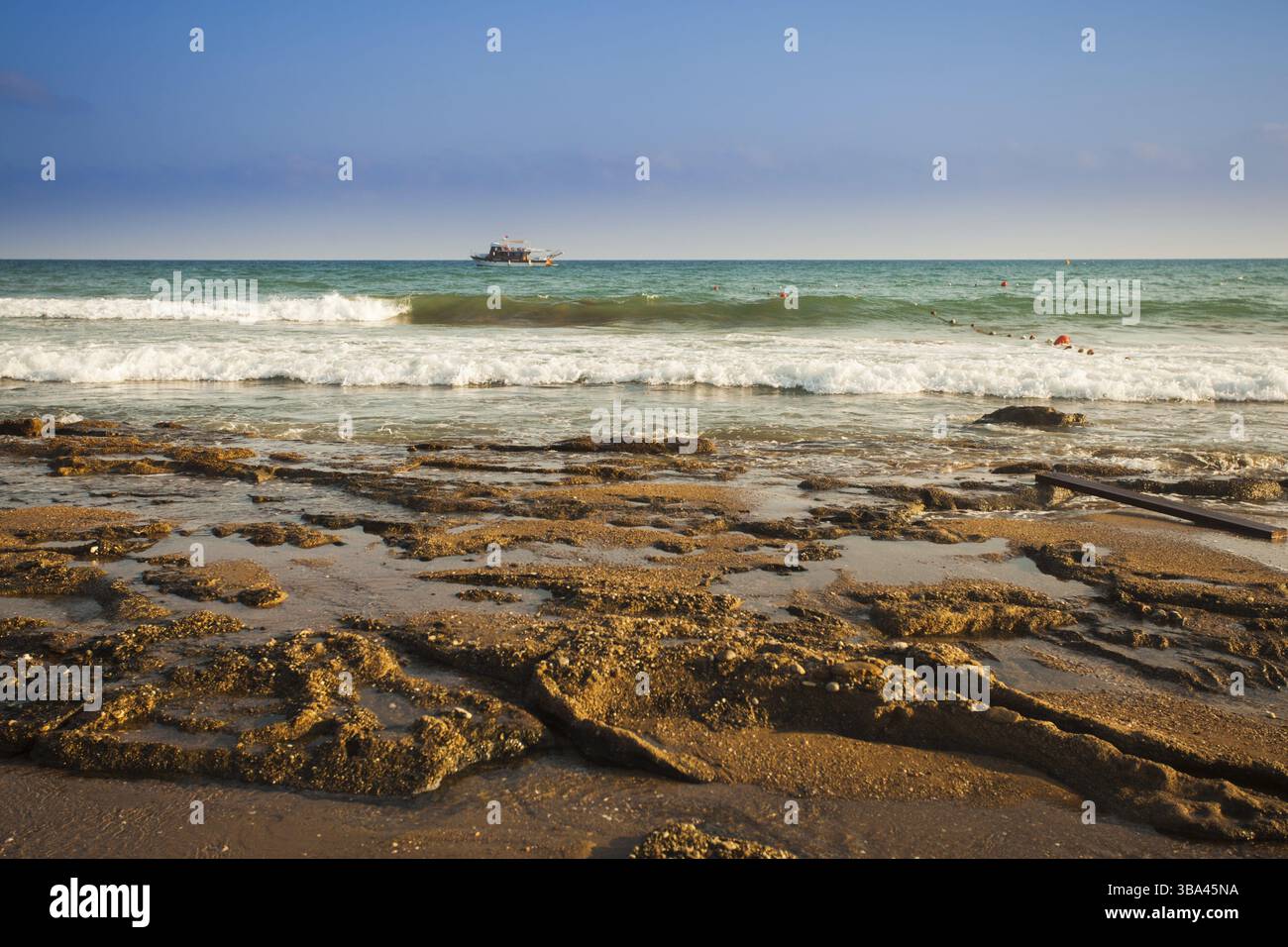 Beautiful seascape with silhouette of walkers on a sandy beach in ...