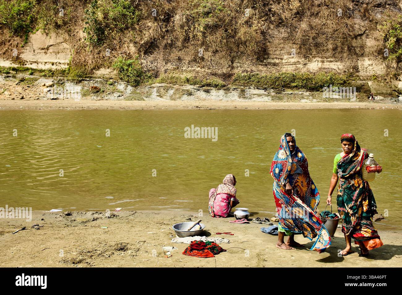 Women wash clothes and bathe in the Sangu River, Bandarban, as ...