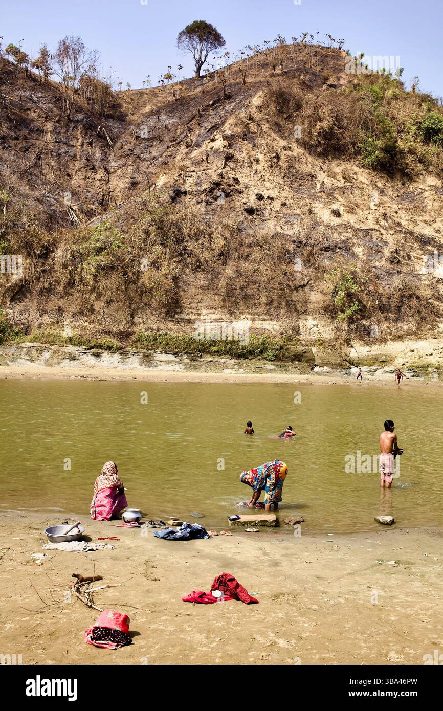 Women wash clothes and bathe in the Sangu River, Bandarban, as ...