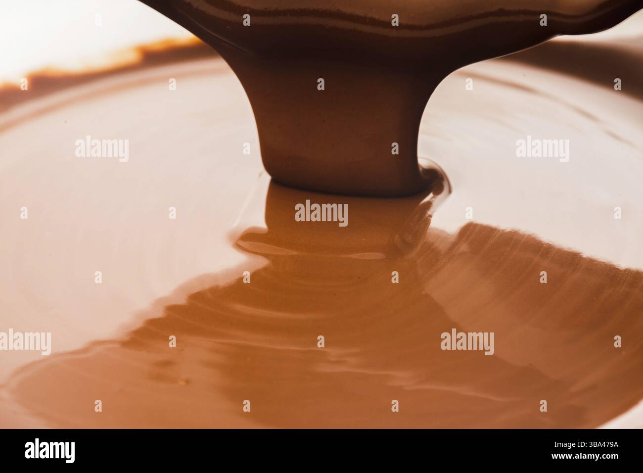 Chocolate flow close up as a background Stock Photo - Alamy
