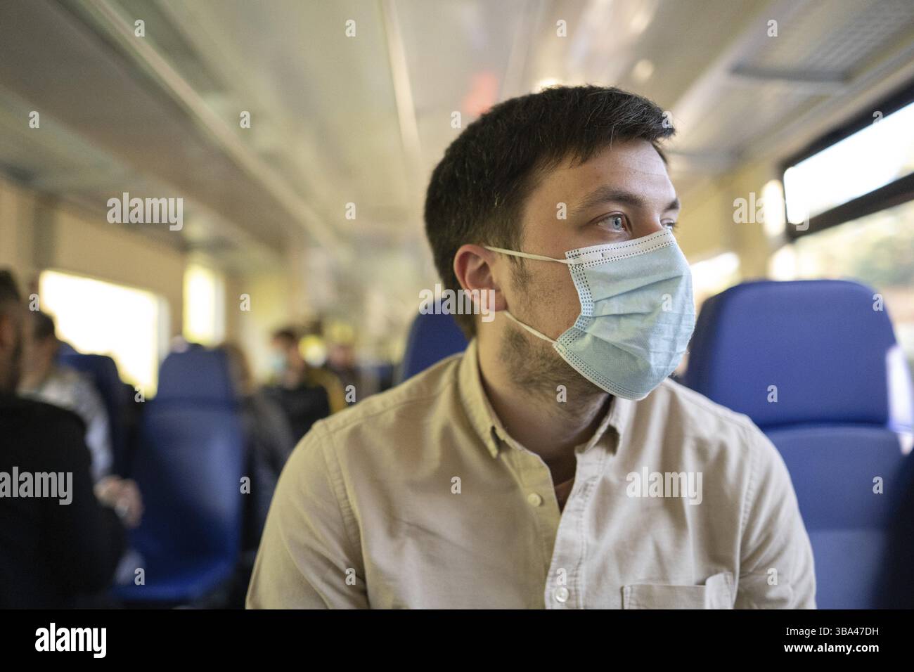 Male passenger wearing face mask during covid-19 lockdown inside train ...