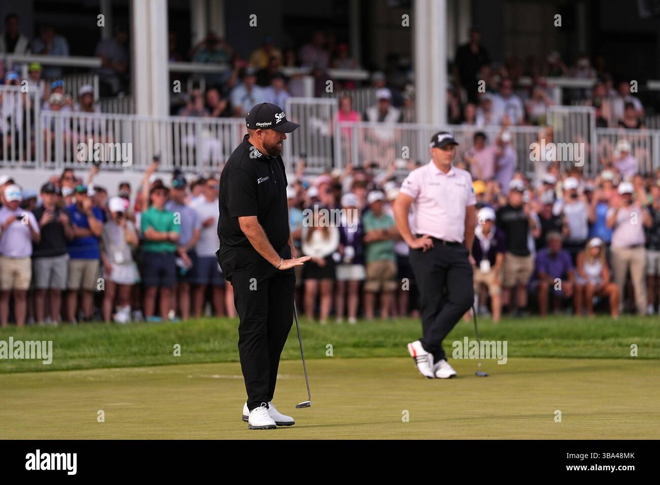 Shane Lowry, of Ireland, reacts after a putt on the 18th hole during ...