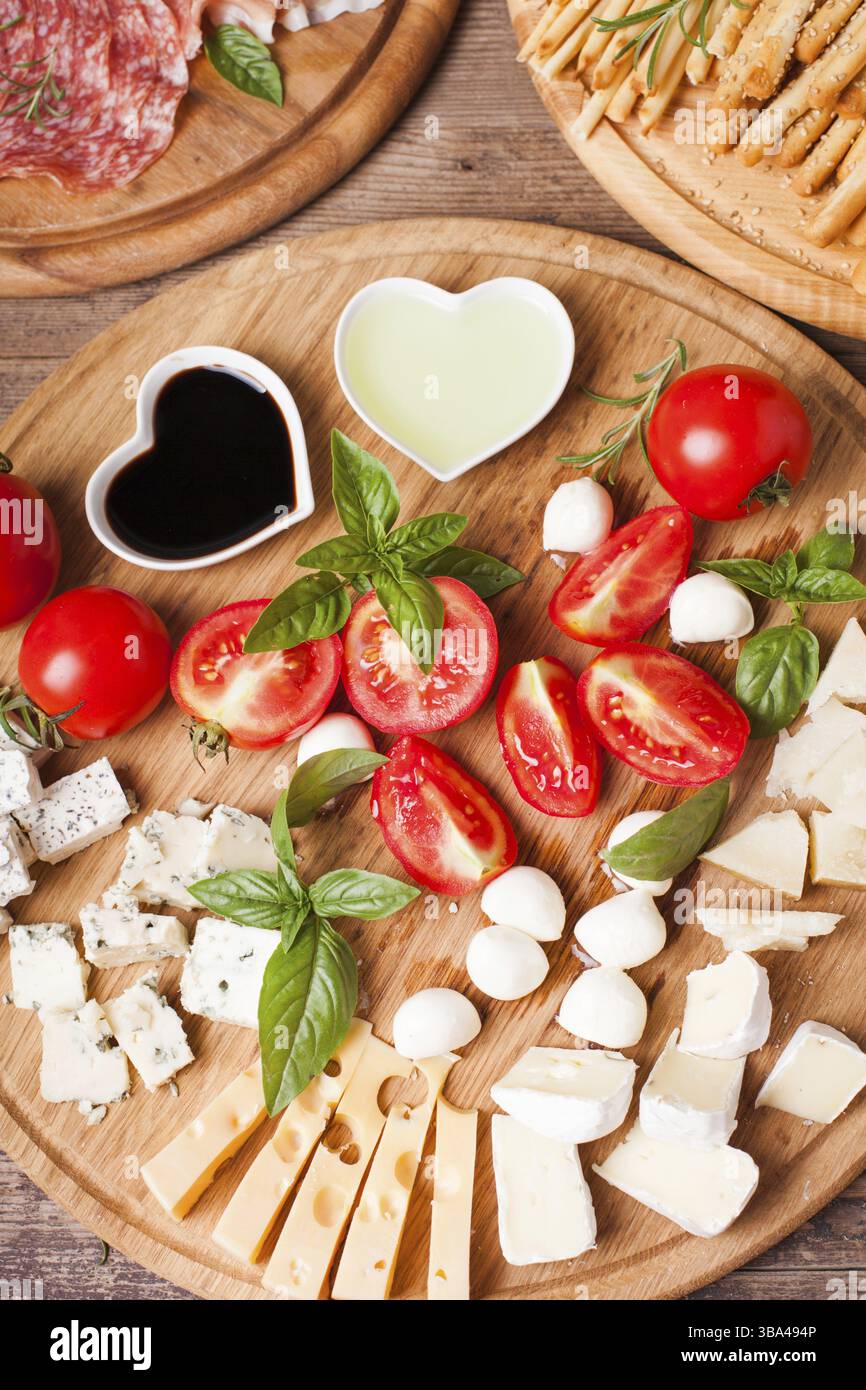 Italian appetizer - various types of ham, cheese and grissini Stock ...