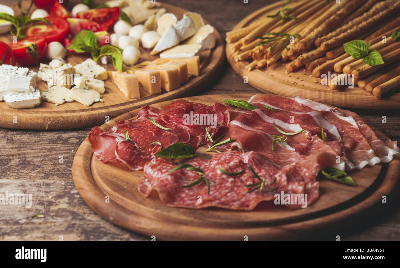 Italian appetizer - various types of ham, cheese and grissini Stock ...