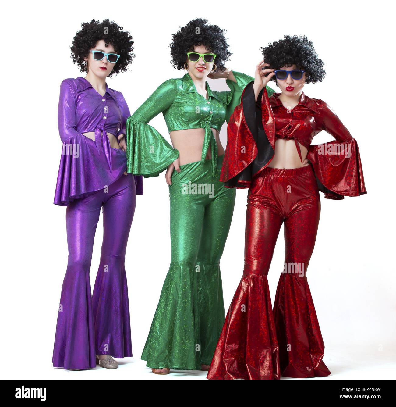 A group of disco girls in African American wigs and colorful costumes ...
