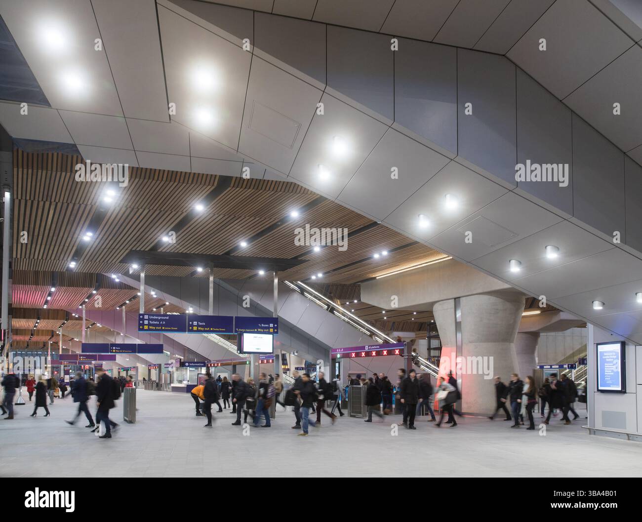 Commuters pass through the modern concourse of London Bridge Station ...