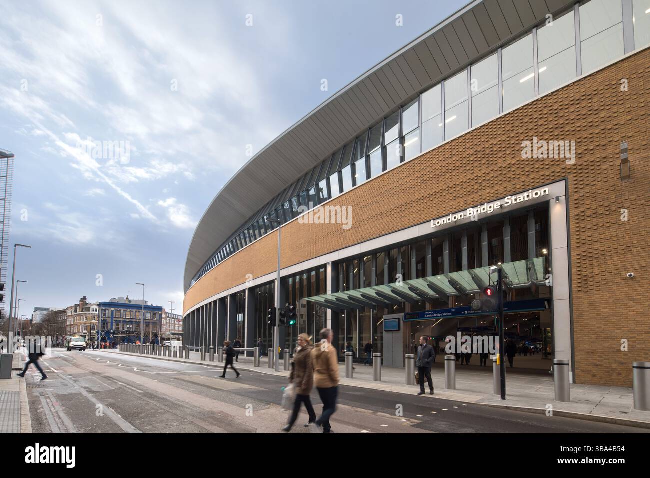 Commuters cross the street outside London Bridge Station, a major rail ...