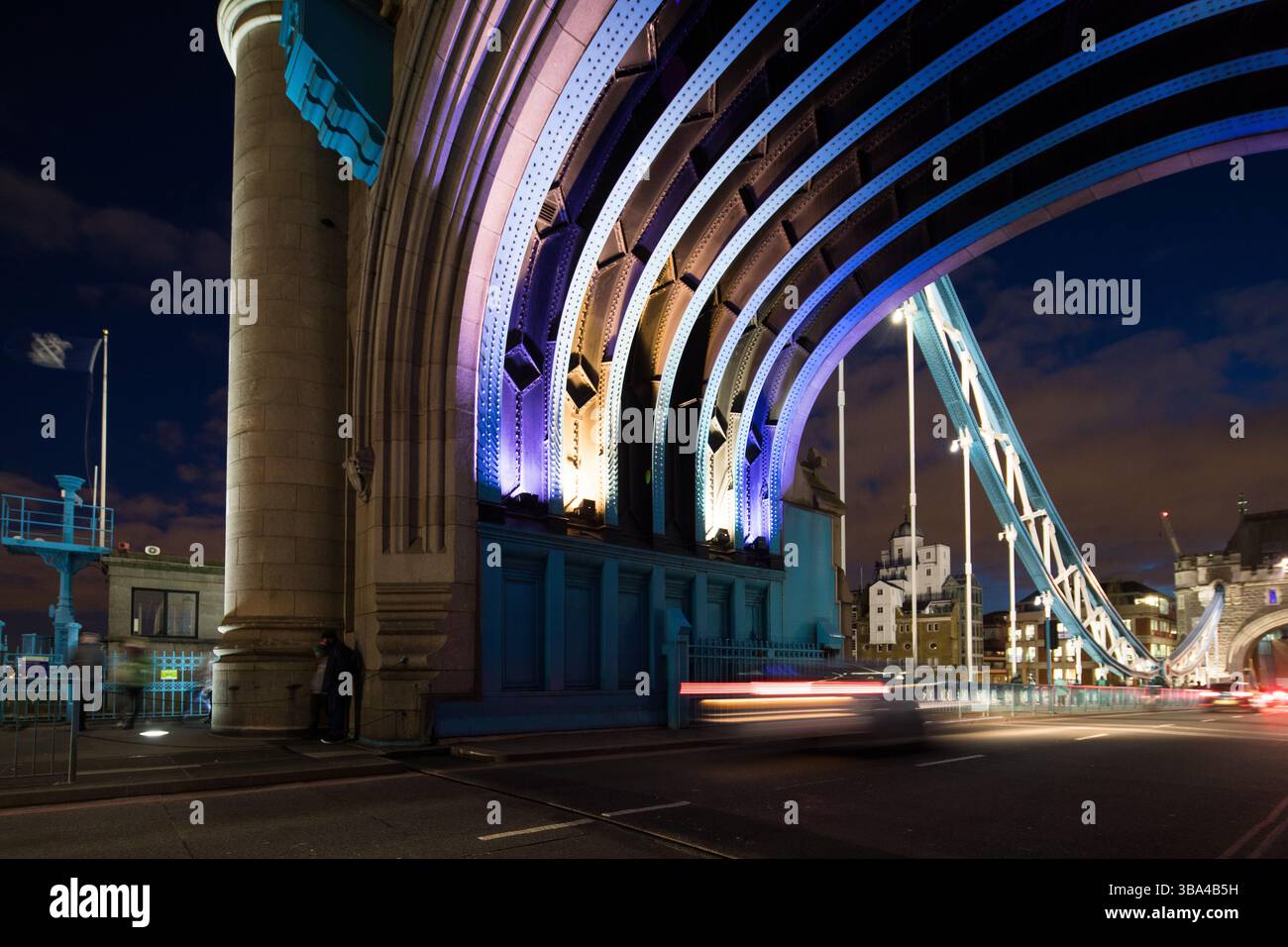 Night scene at Tower Bridge, London. Cars streak by, capturing the ...