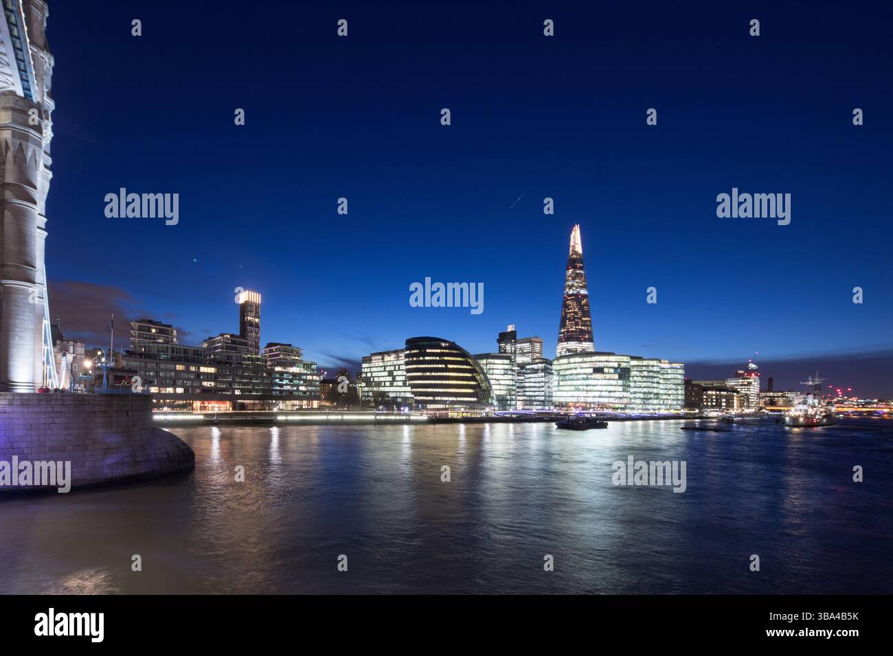 Night view from Tower Bridge, London. The Shard, City Hall, and HMS ...