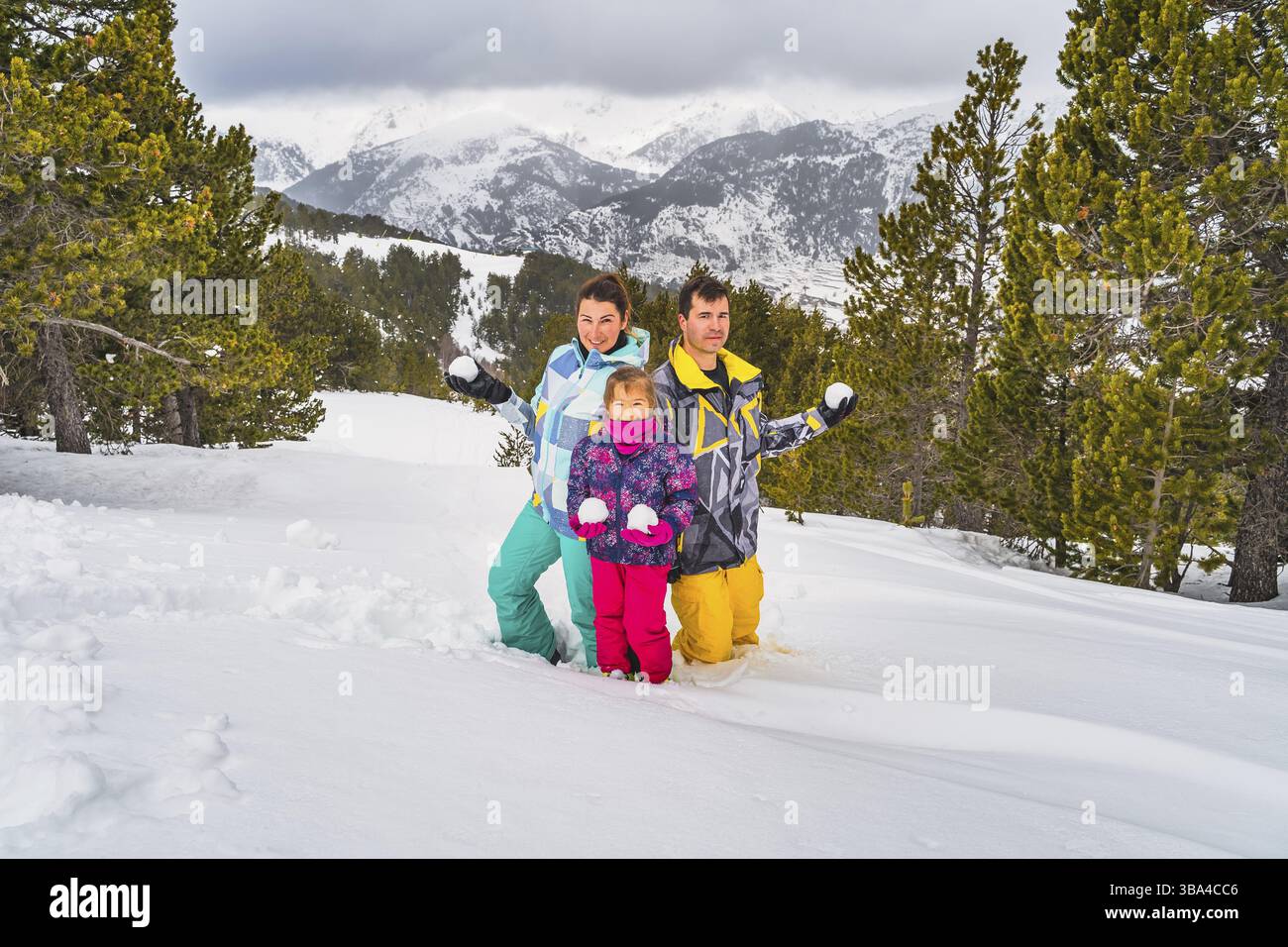 Family, mother, father and daughter holding snowballs, ready for a snow ...