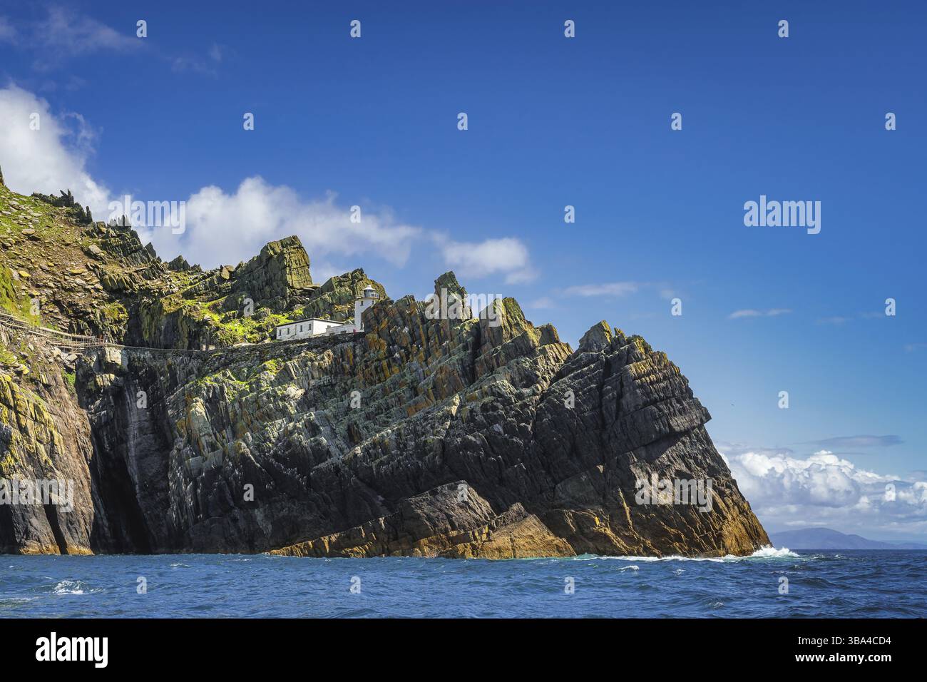 Skellig Lighthouse located on the edge of the cliff on Skellig Michael ...