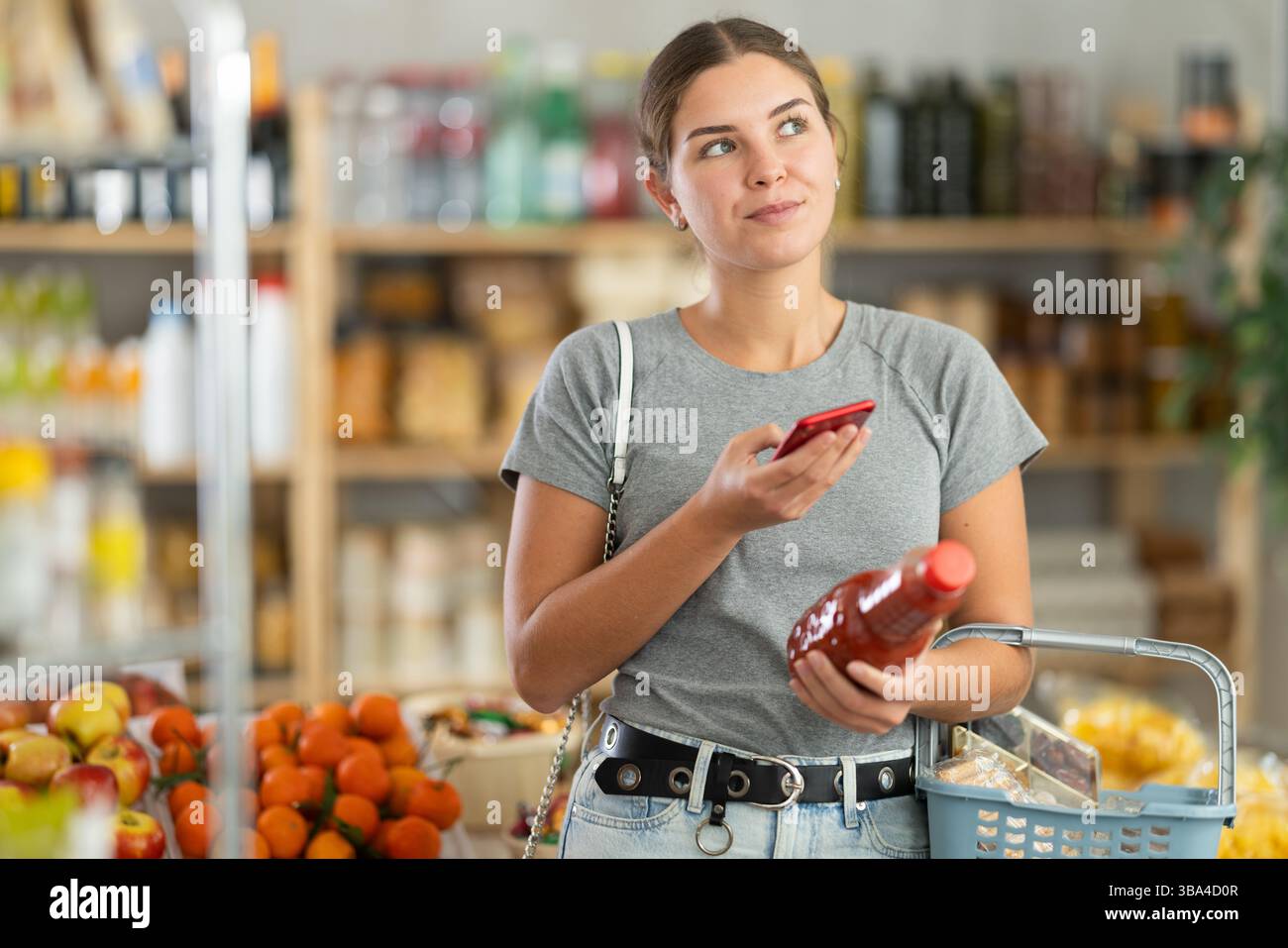 Young woman scanning qr code of tomato juice Stock Photo - Alamy