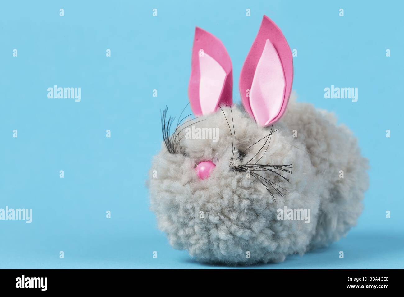 Fluffy Easter Bunny toy with pink ears on a blue background Stock Photo ...