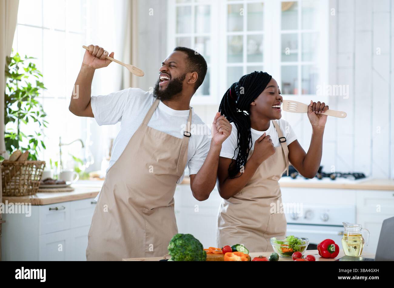 Kitchen Concert. Cheerful Black Couple Having Fun While Cooking ...