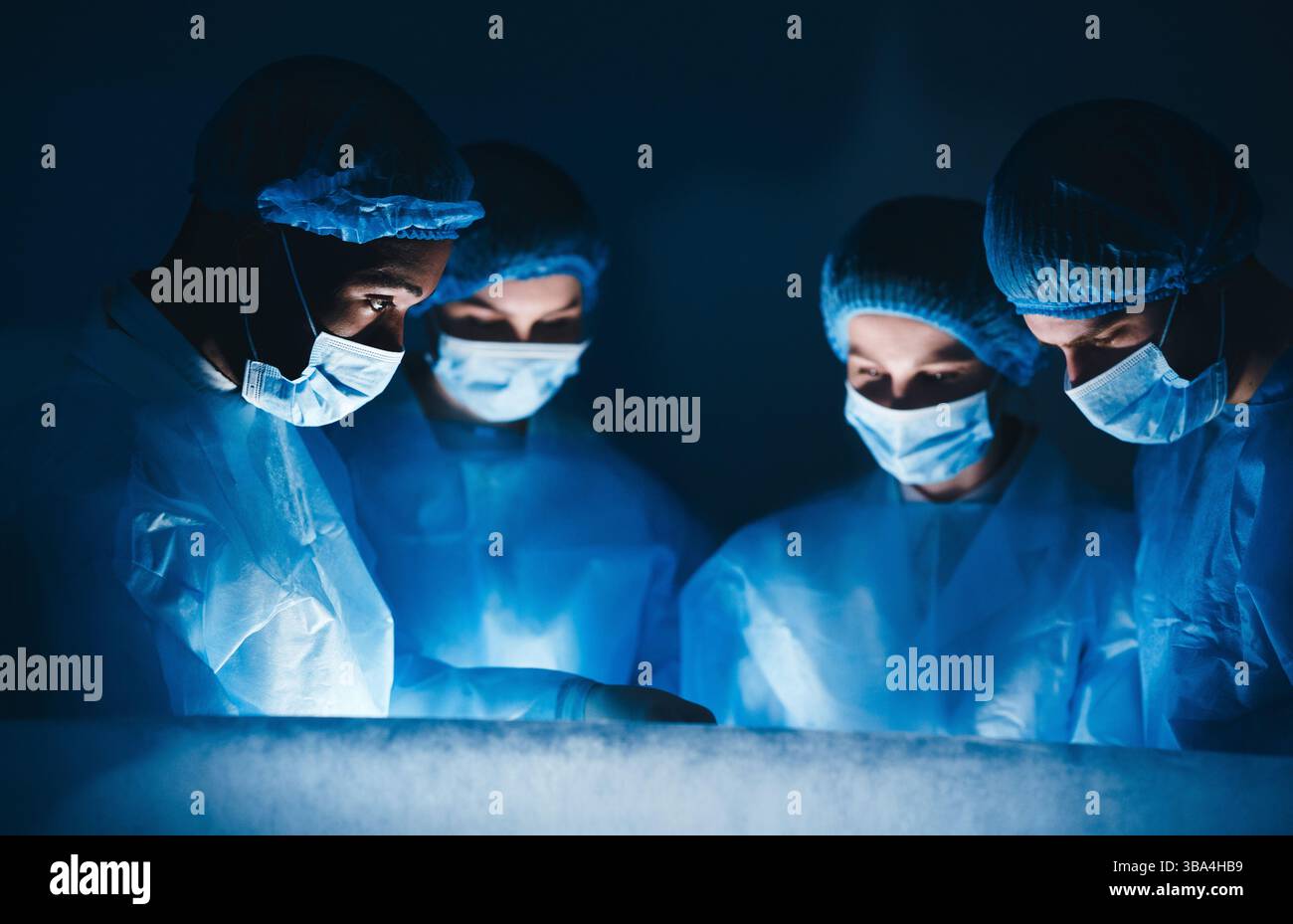 Medical Team Performing Surgical Operation in Dark Room Stock Photo - Alamy