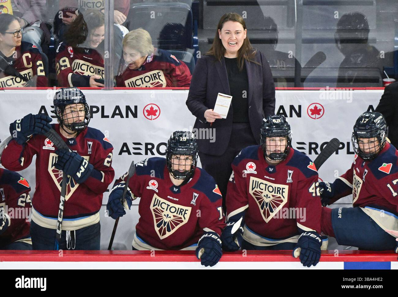 Montreal Victoire head coach Kori Cheverie, center top, looks on from ...