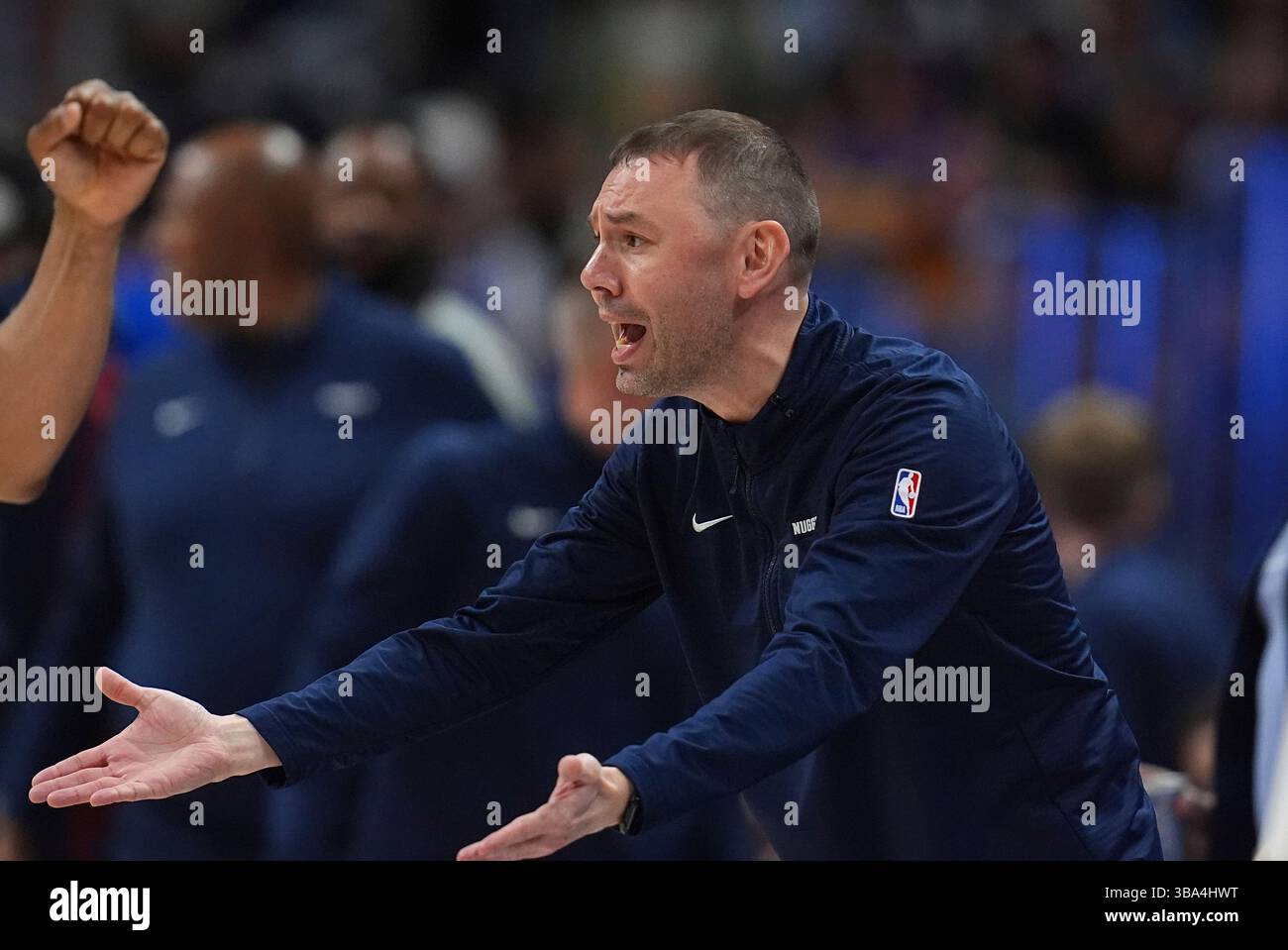 Denver Nuggets interim head coach David Adelman argues for a call in ...